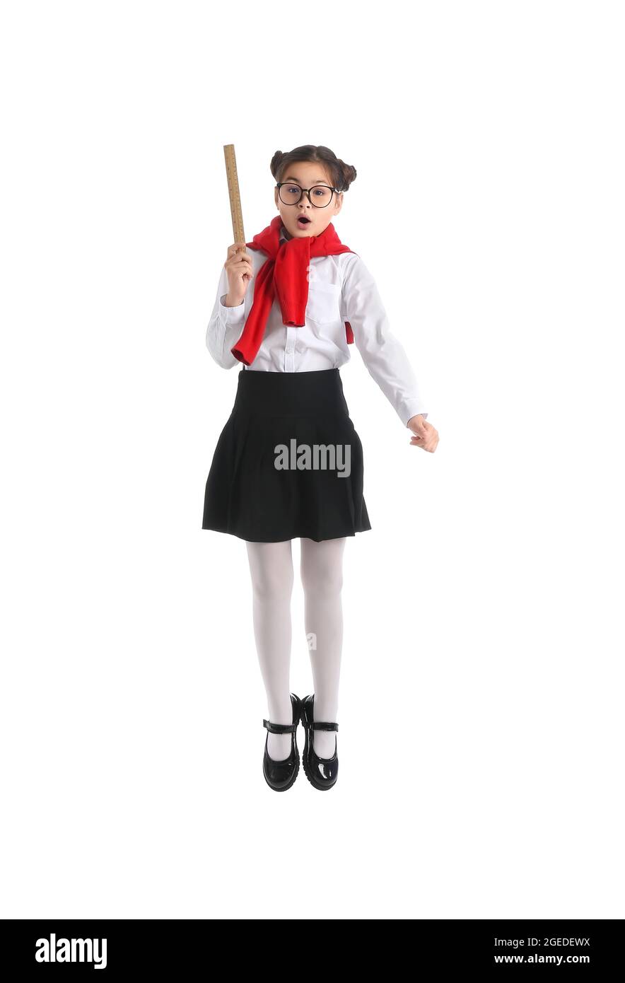 Jumping little schoolgirl with ruler on white background Stock Photo ...