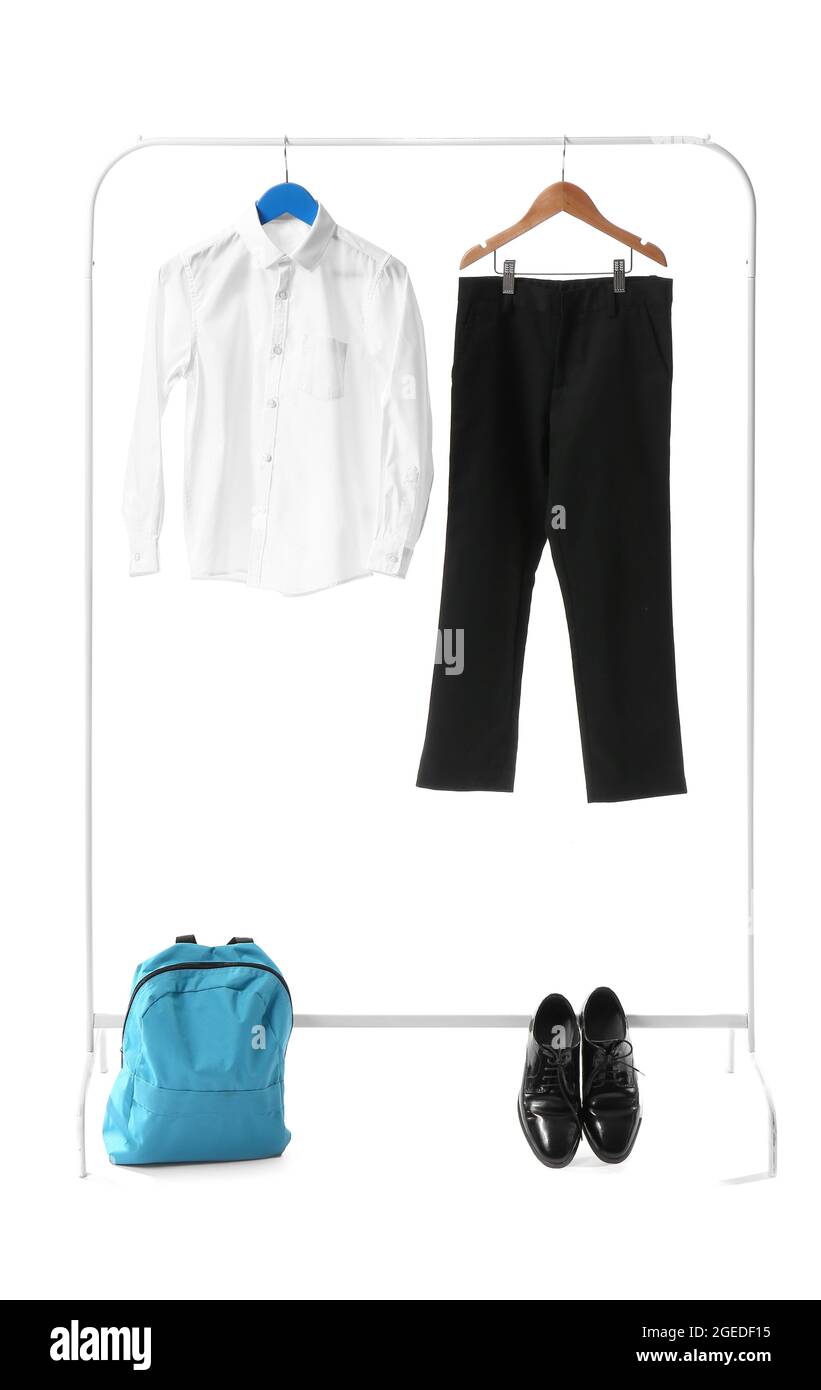 Rack with school uniform on white background Stock Photo - Alamy