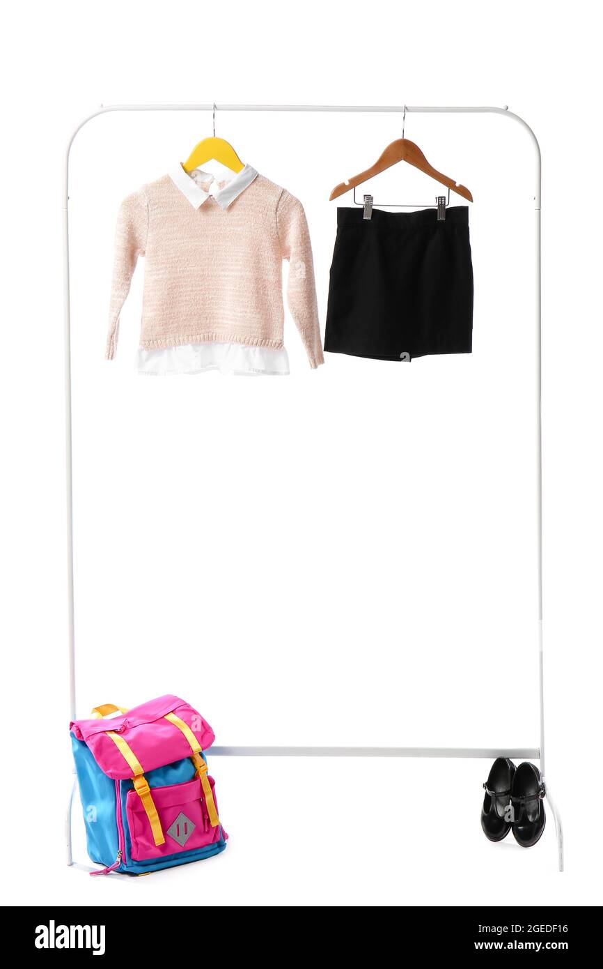 Rack with stylish school uniform on white background Stock Photo - Alamy