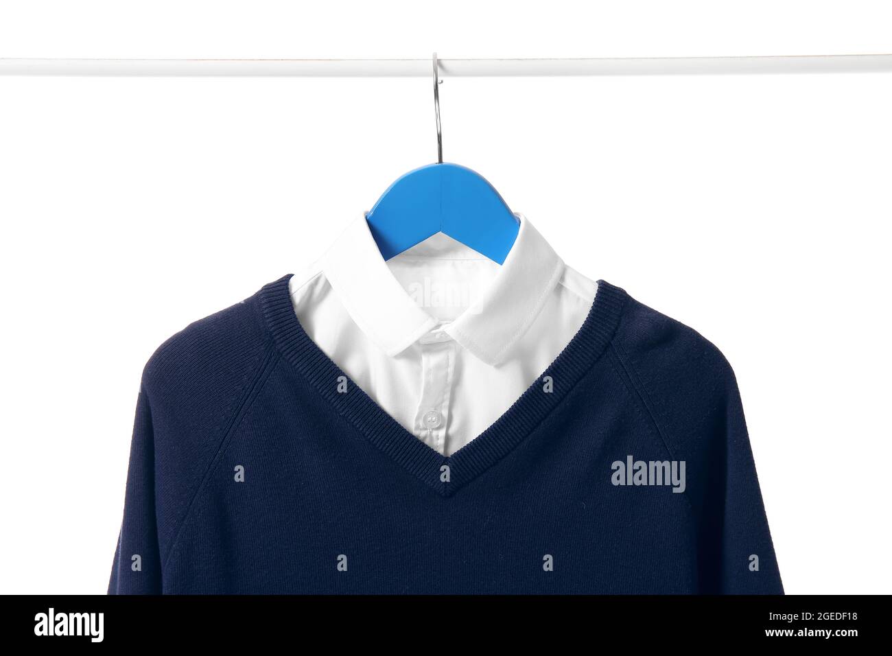 Hanger with stylish school uniform on white background Stock Photo - Alamy