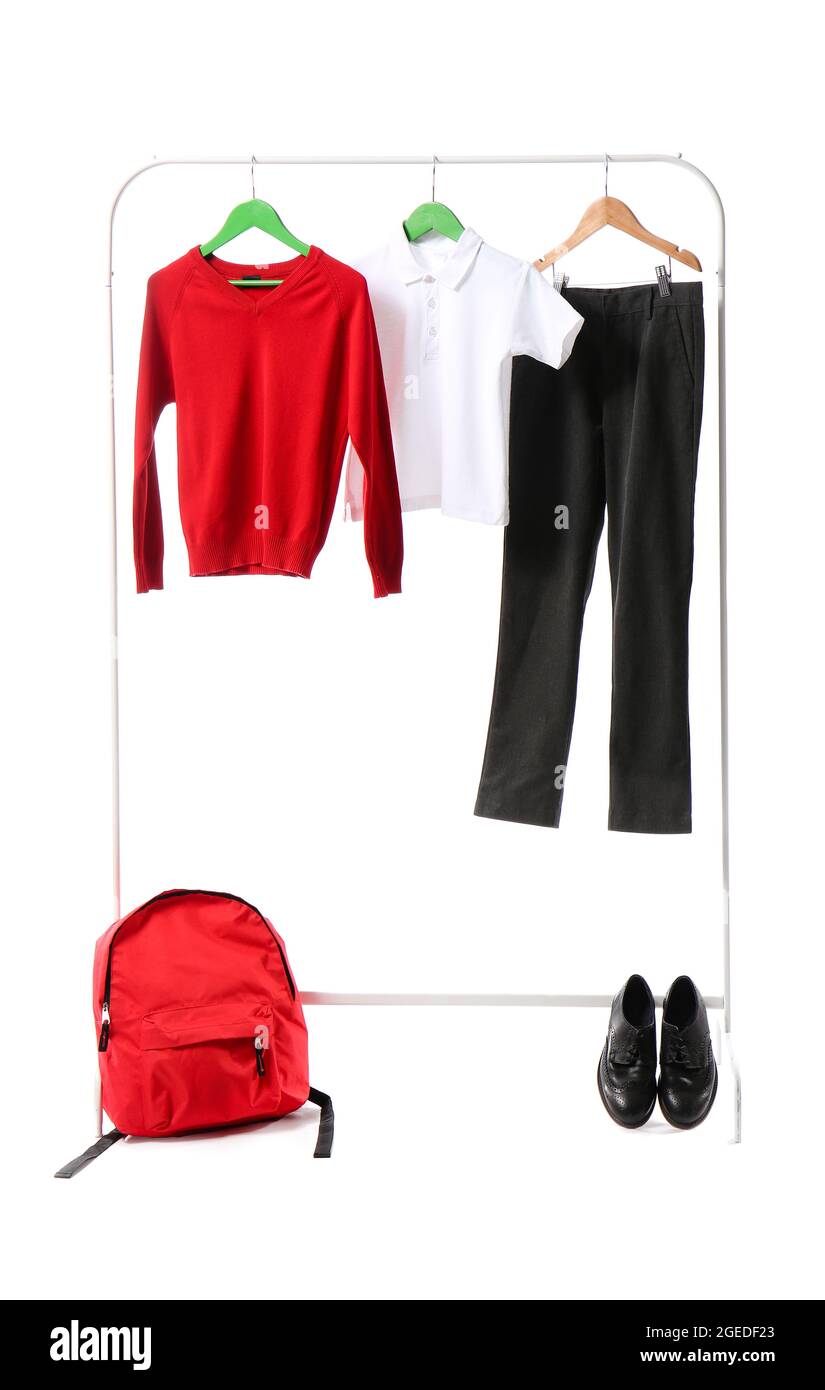 Rack with stylish school uniform on white background Stock Photo - Alamy