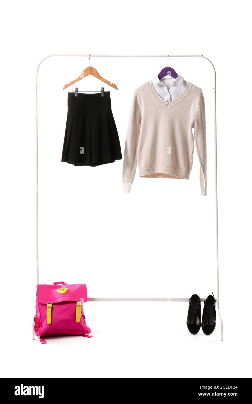 Rack with stylish school uniform on white background Stock Photo - Alamy