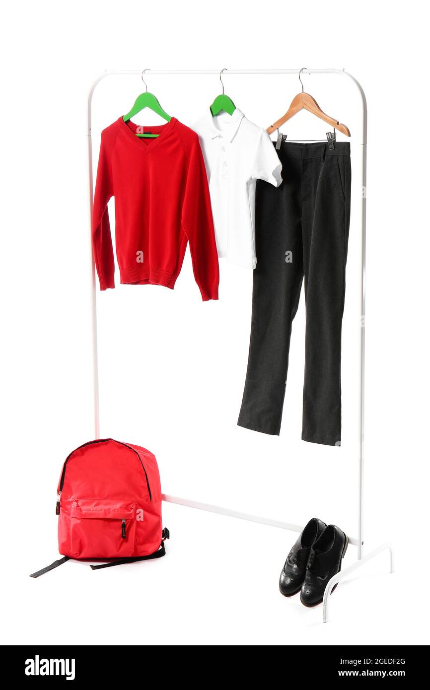 Rack with stylish school uniform on white background Stock Photo - Alamy