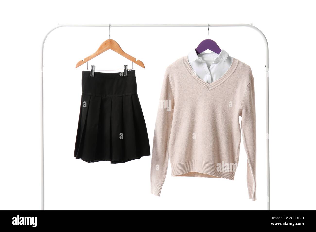 Rack with stylish school uniform on white background Stock Photo - Alamy