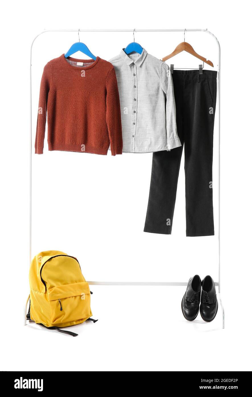 Rack with stylish school uniform on white background Stock Photo - Alamy