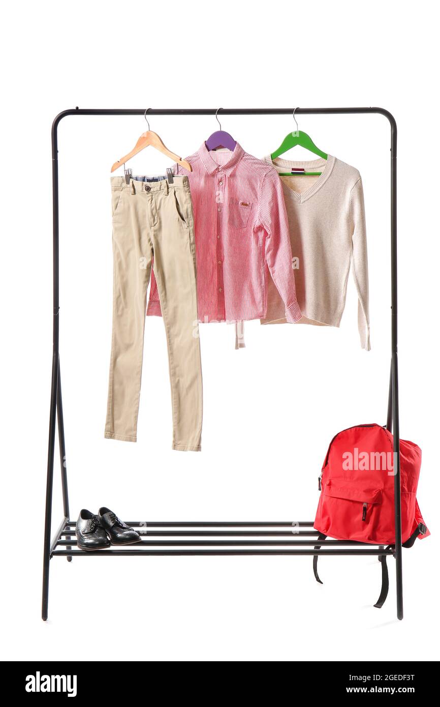 Rack with stylish school uniform on white background Stock Photo - Alamy