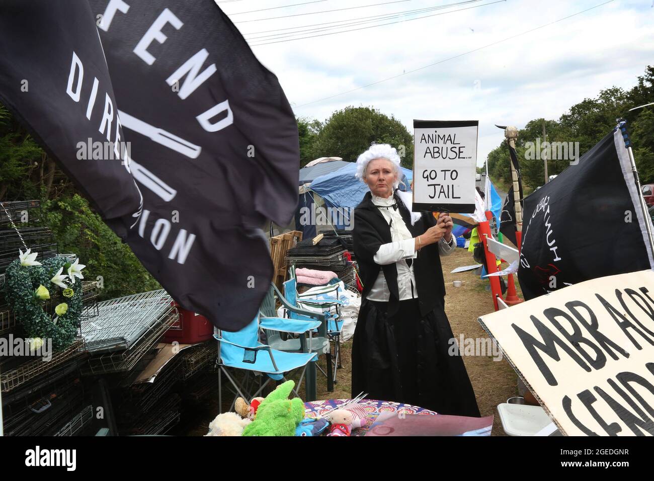 A protester dressed as a judge holds up a sign reading "Animal Abuse ...