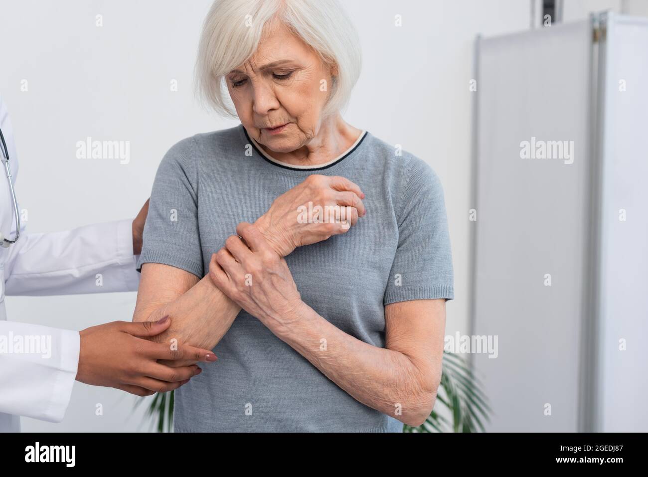 Woman touching arm hi-res stock photography and images - Alamy