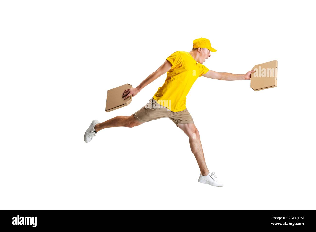 Young delivery man in yellow uniform running to deliver order isolated ...