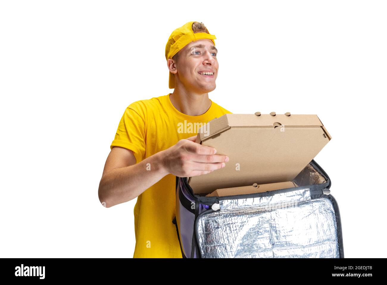 Close up young delivery man in yellow uniform with paper box with pizza ...