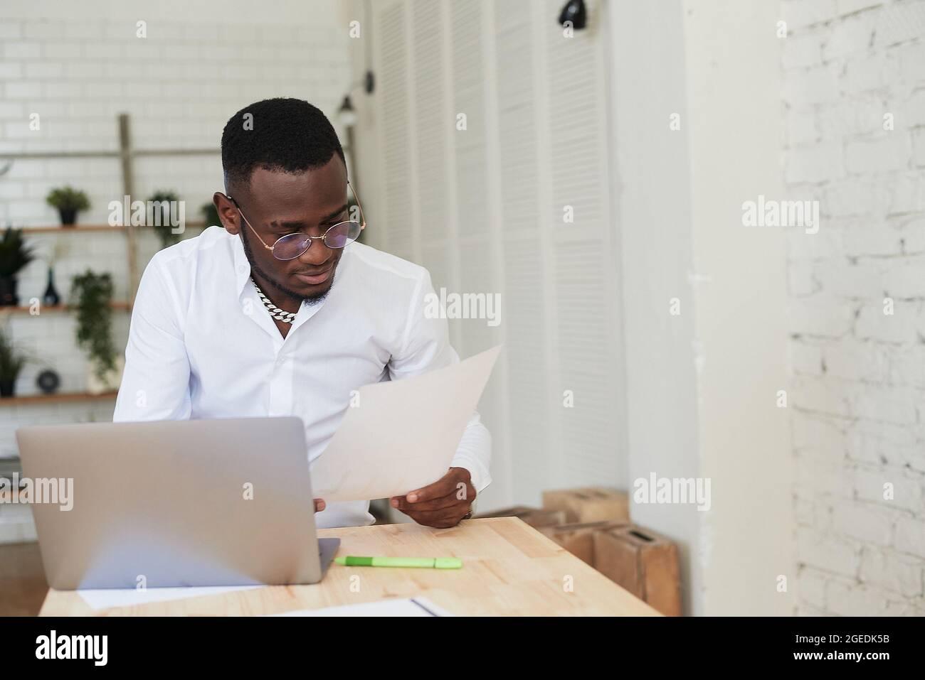Happy focused African American man making a video call with customer ...