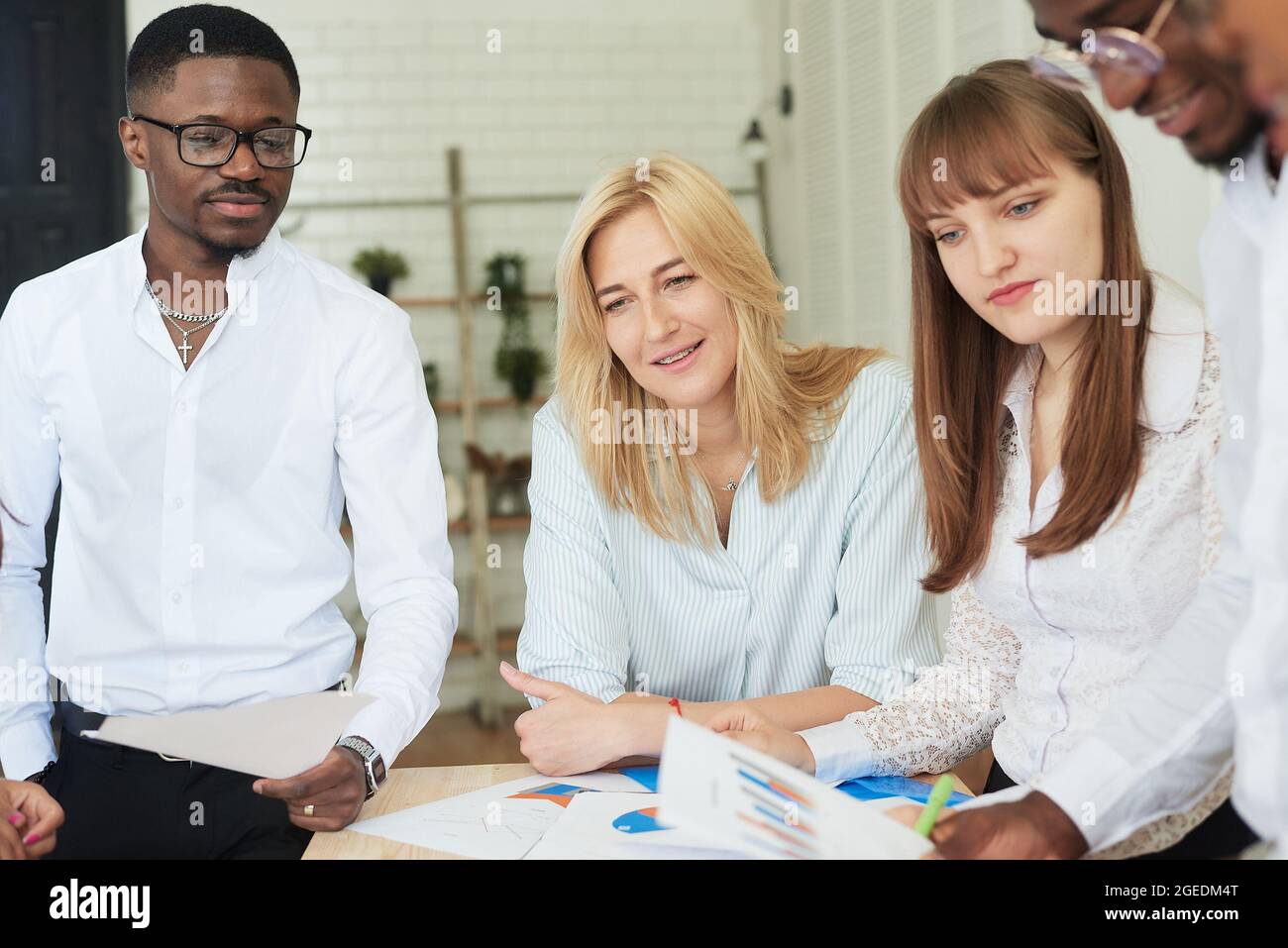 A multinational positive company of people works in the office and ...