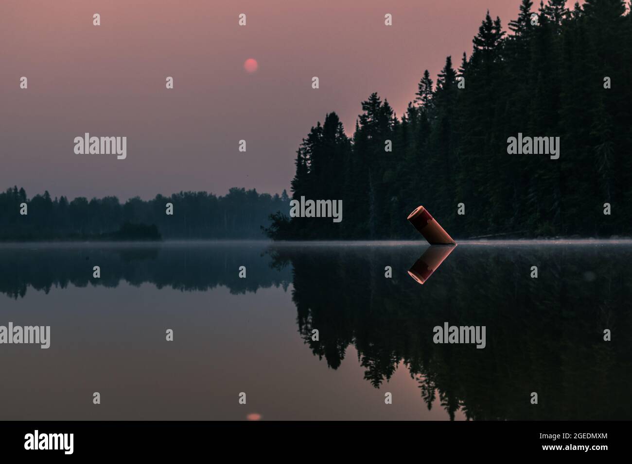 Peaceful river in the early morning with forest fire smoke covering the ...