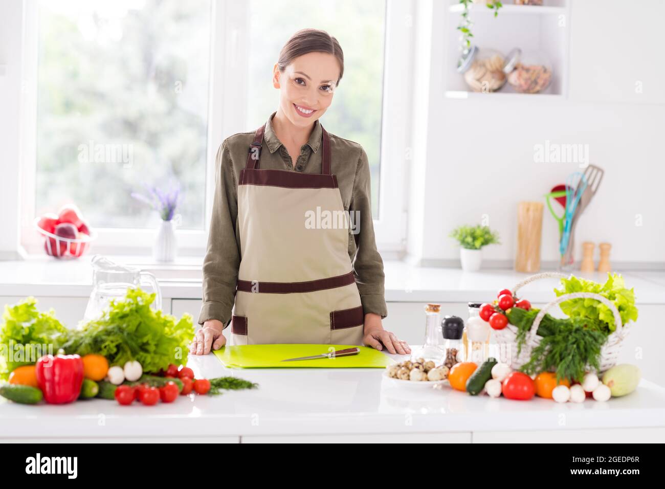 Portrait of attractive cheerful girl cooking tasty yummy salad ...