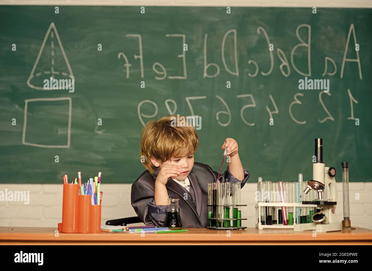 Little boy at the elementary school. school kid scientist studying ...