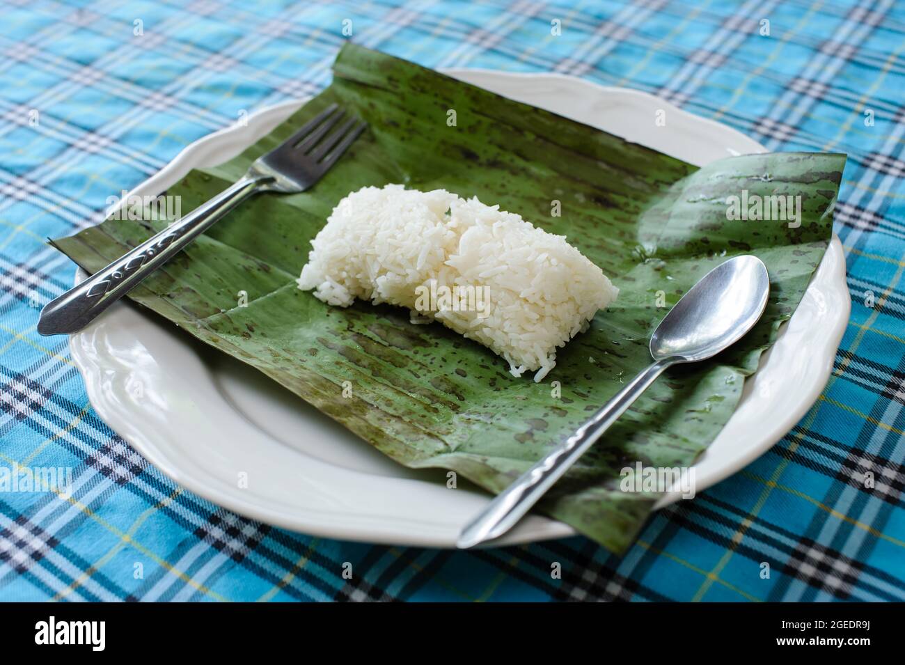 steamed rice with banana leaf spoon and folk on a dish Stock Photo - Alamy