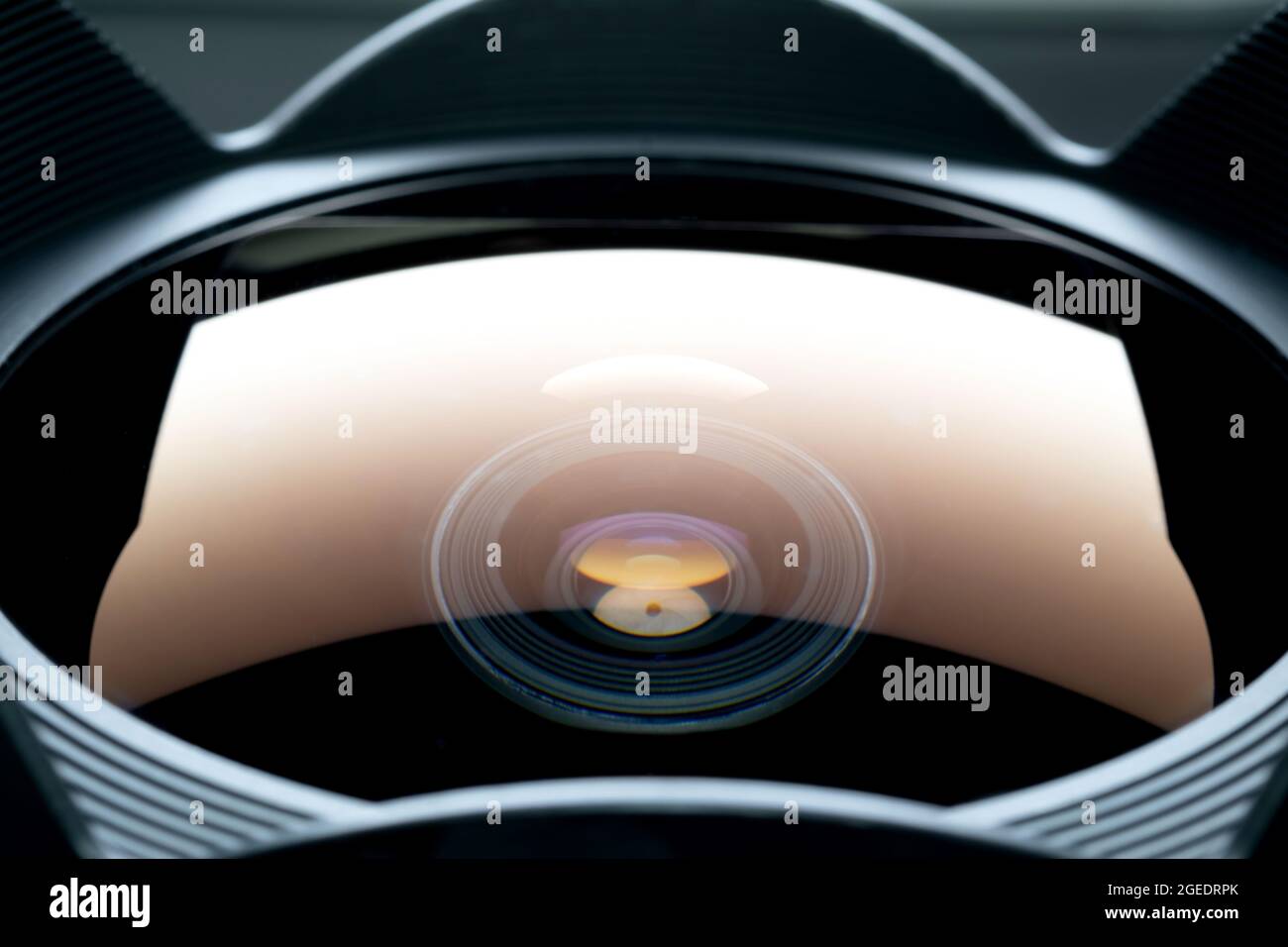 close up shot of lens surface with reflection of light box with narrow ...