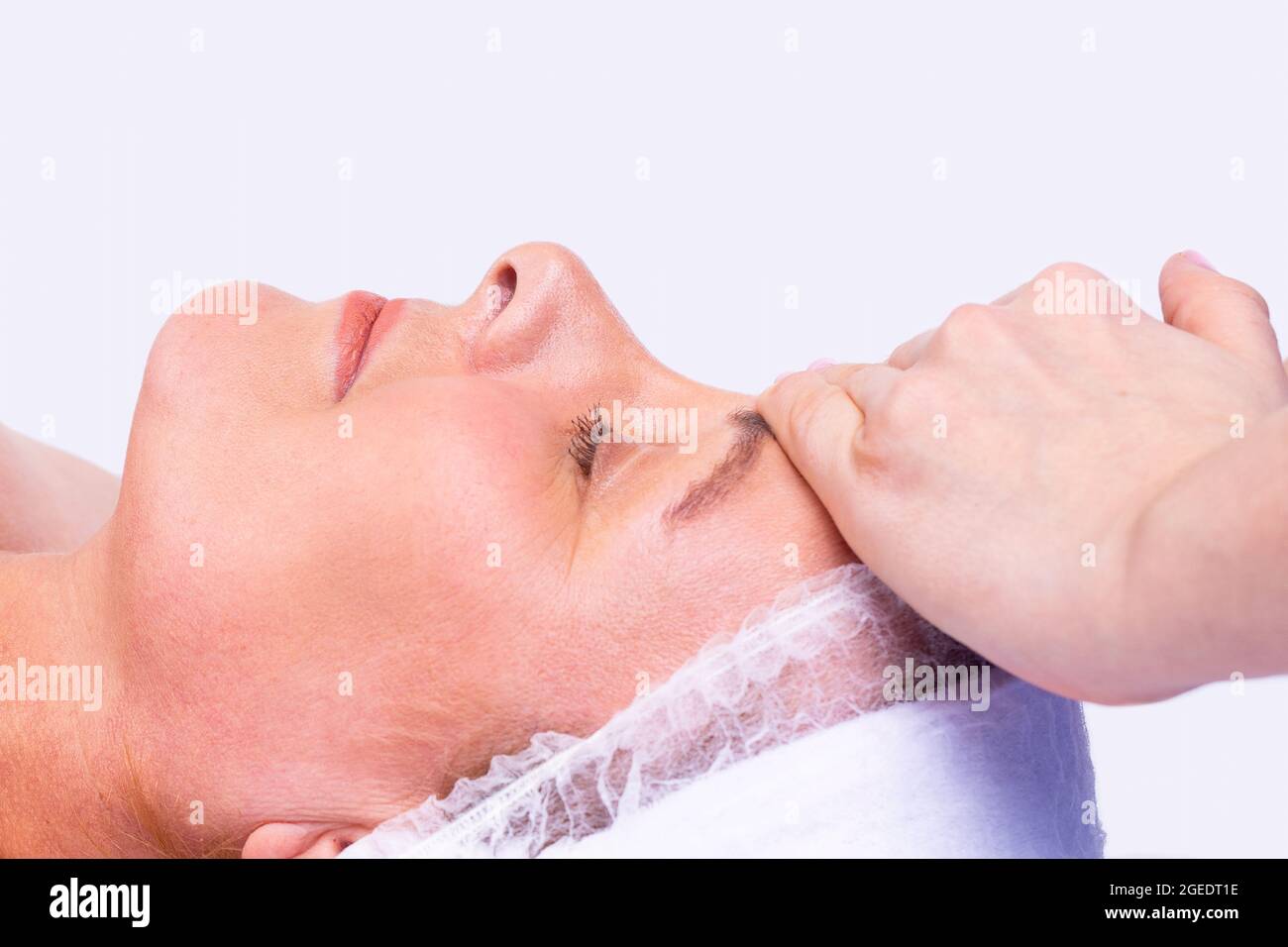 Close up photo of a woman face being in the spa salon undergoes a ...