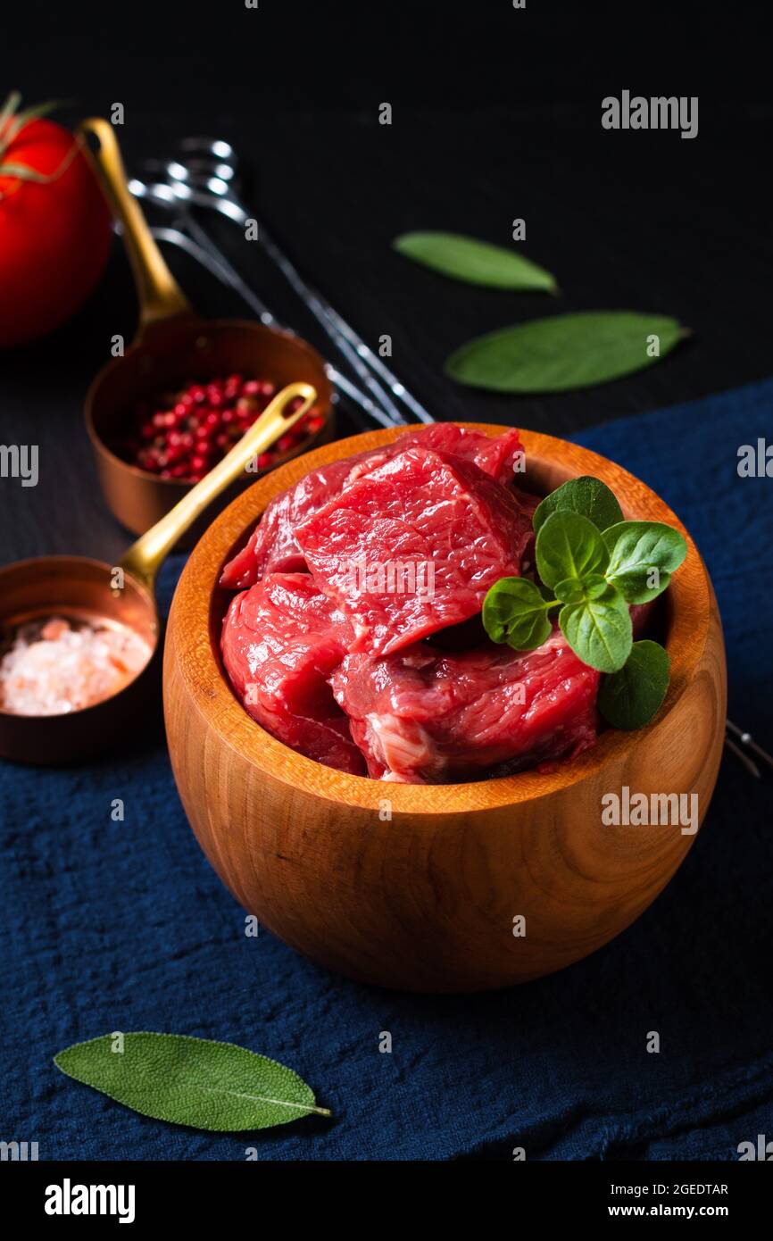 Food concept Farmer organic Raw cube cut beef meat in wooden bowl with ...