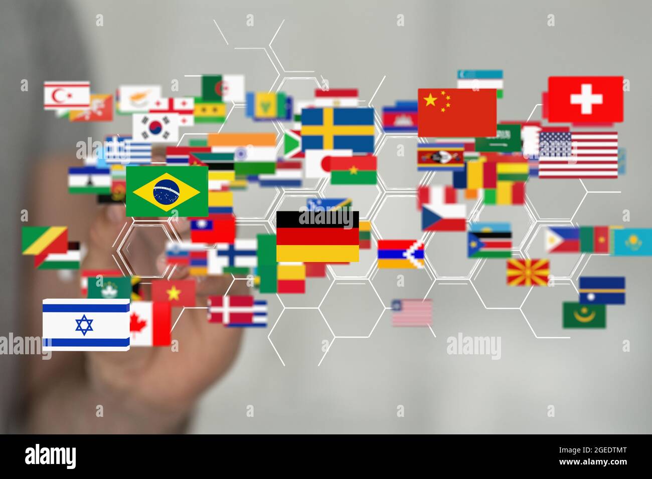 Finger touching a digital illustration of national flags of the ...