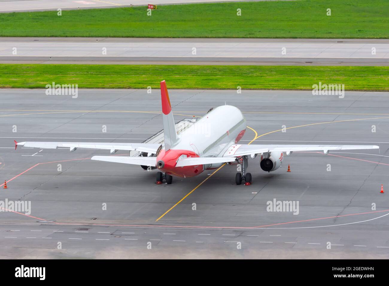 Airplane parked at the airport apron, rear view Stock Photo - Alamy