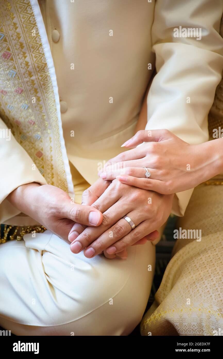 wedding rings together in hands Stock Photo - Alamy