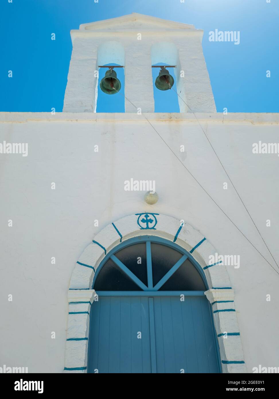 Belfry two bells small whitewashed chapel door with arch Kimolos island ...