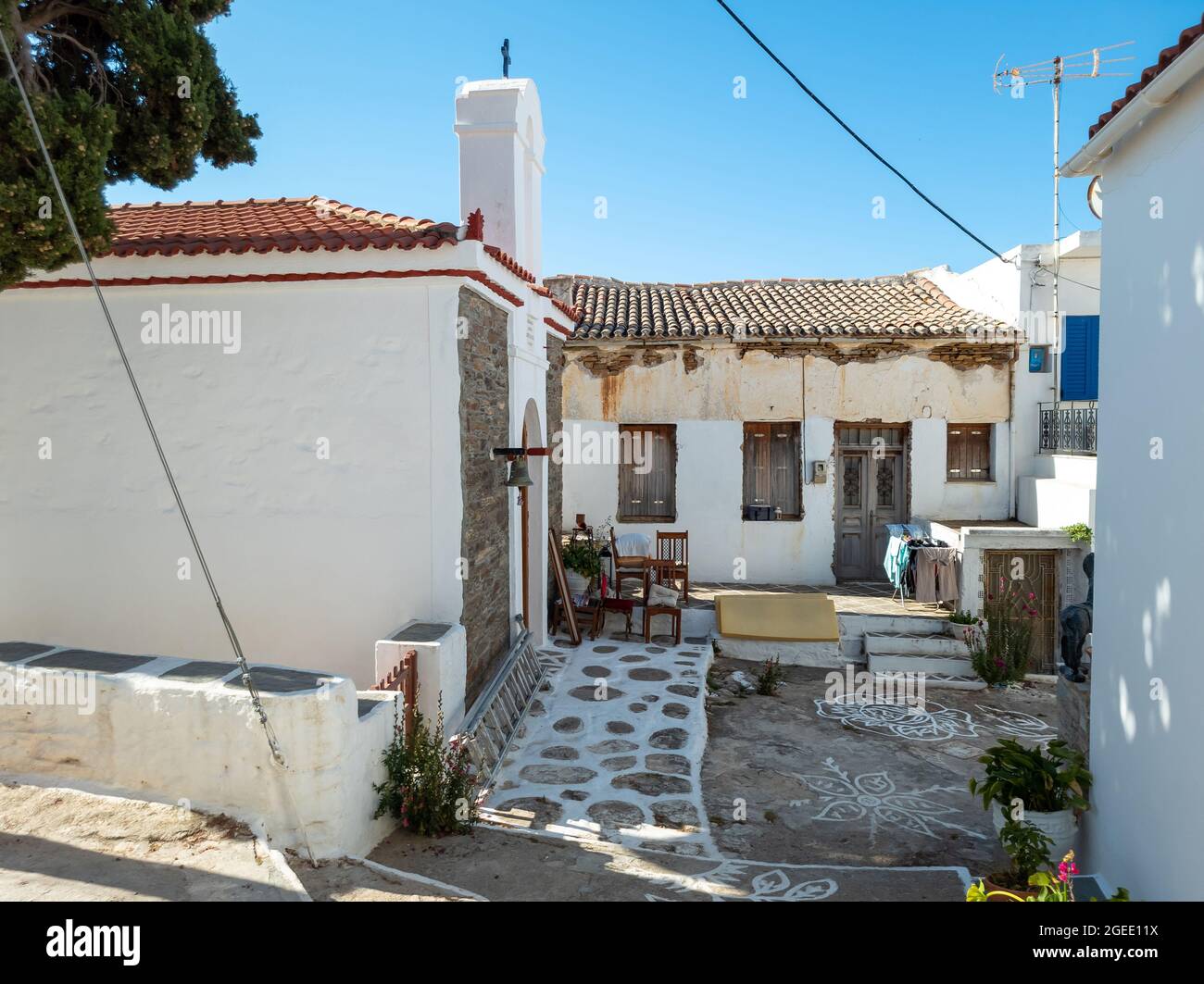 Old rusty traditional roof tiled house next to Cyclades architecture ...