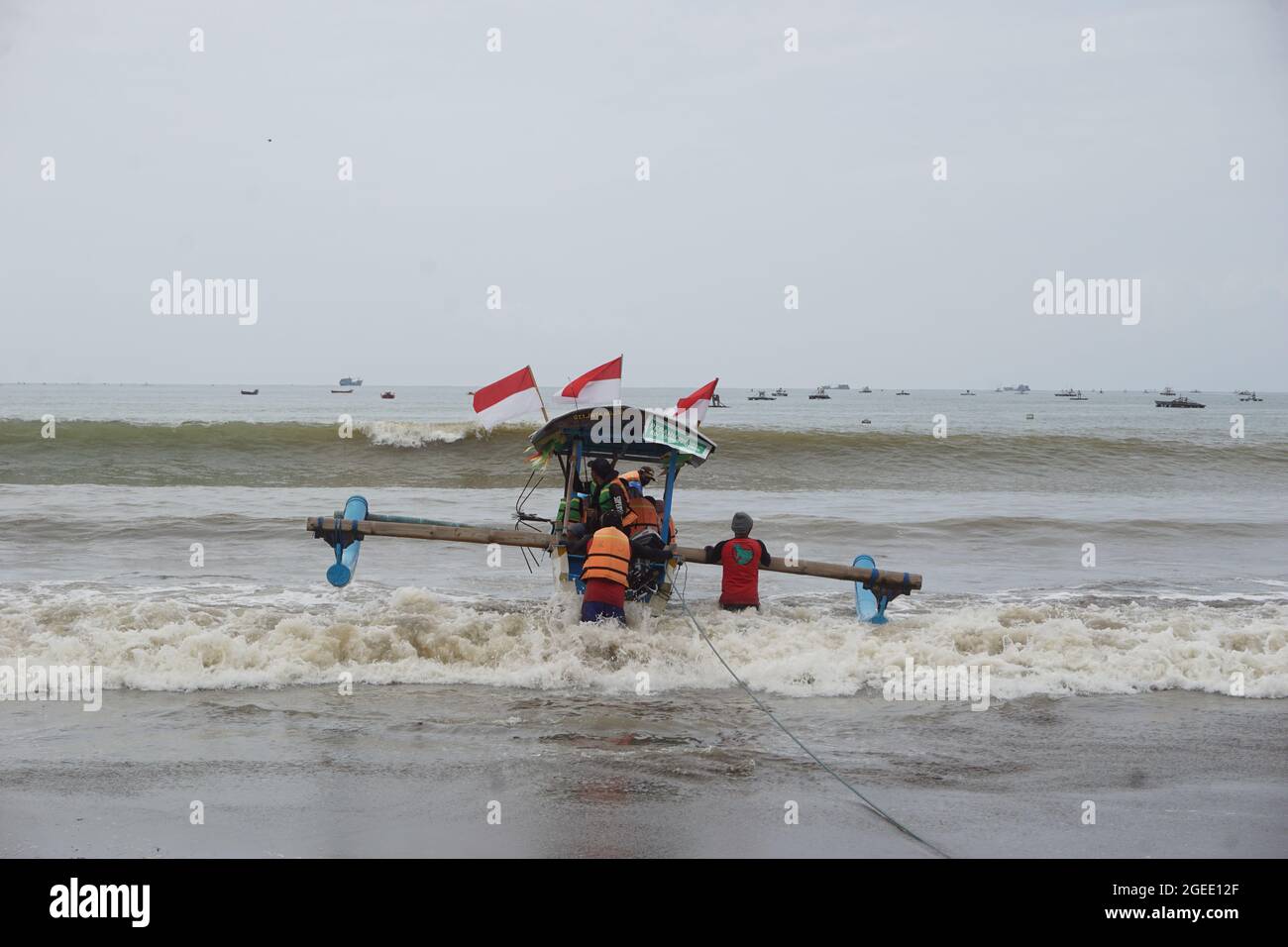 Children are playing on the traditional boat in Gemah Beach, Tulung ...