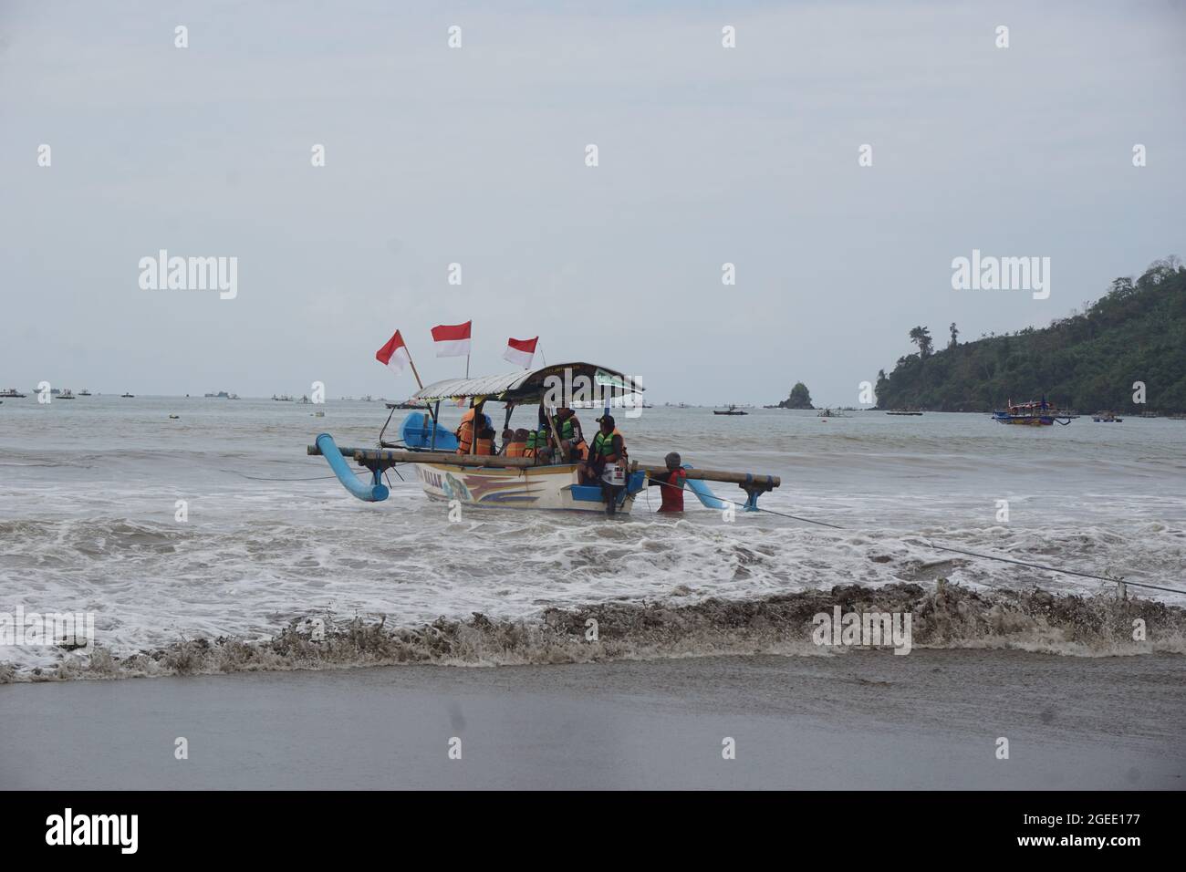 Children are playing on the traditional boat in Gemah Beach, Tulung ...
