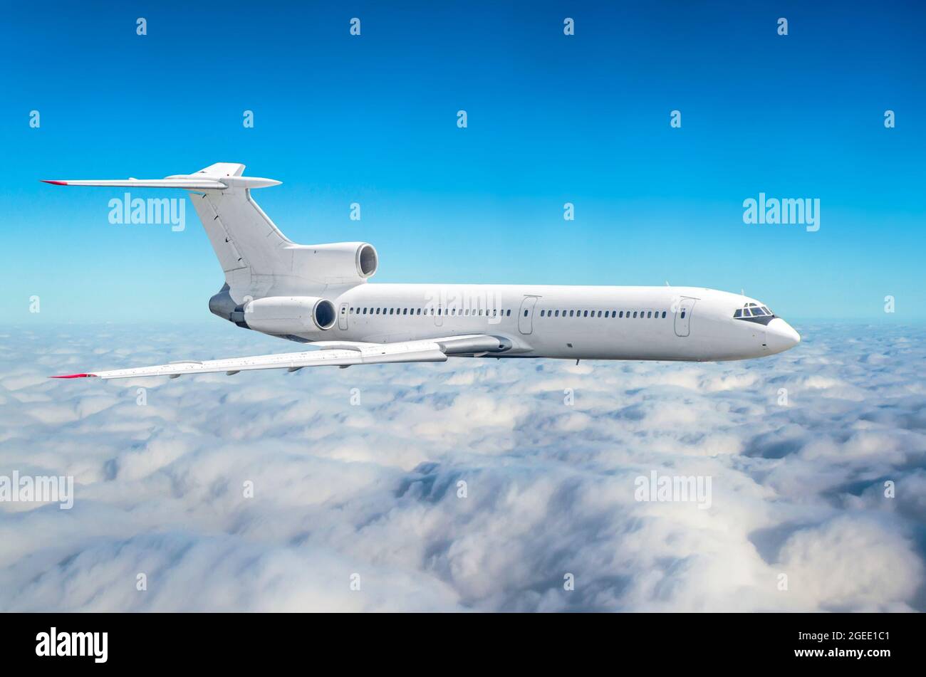 Airplane with three engines on tail in the sky above the clouds flight ...