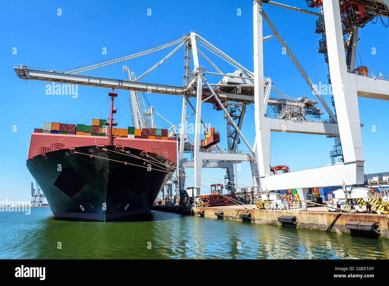A container ship at the dock loaded by a container gantry crane Stock ...