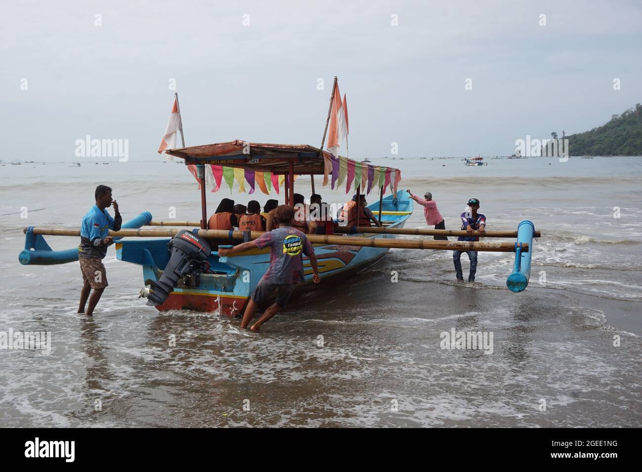 Children are playing on the traditional boat in Gemah Beach, Tulung ...