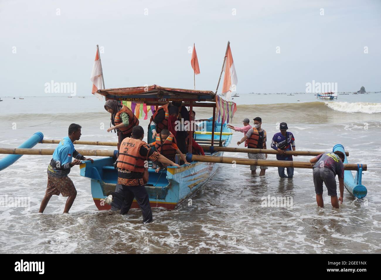 Children are playing on the traditional boat in Gemah Beach, Tulung ...