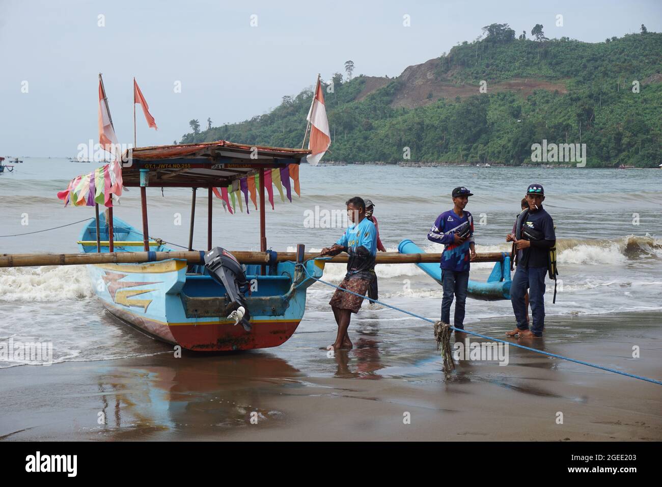 Children are playing on the traditional boat in Gemah Beach, Tulung ...