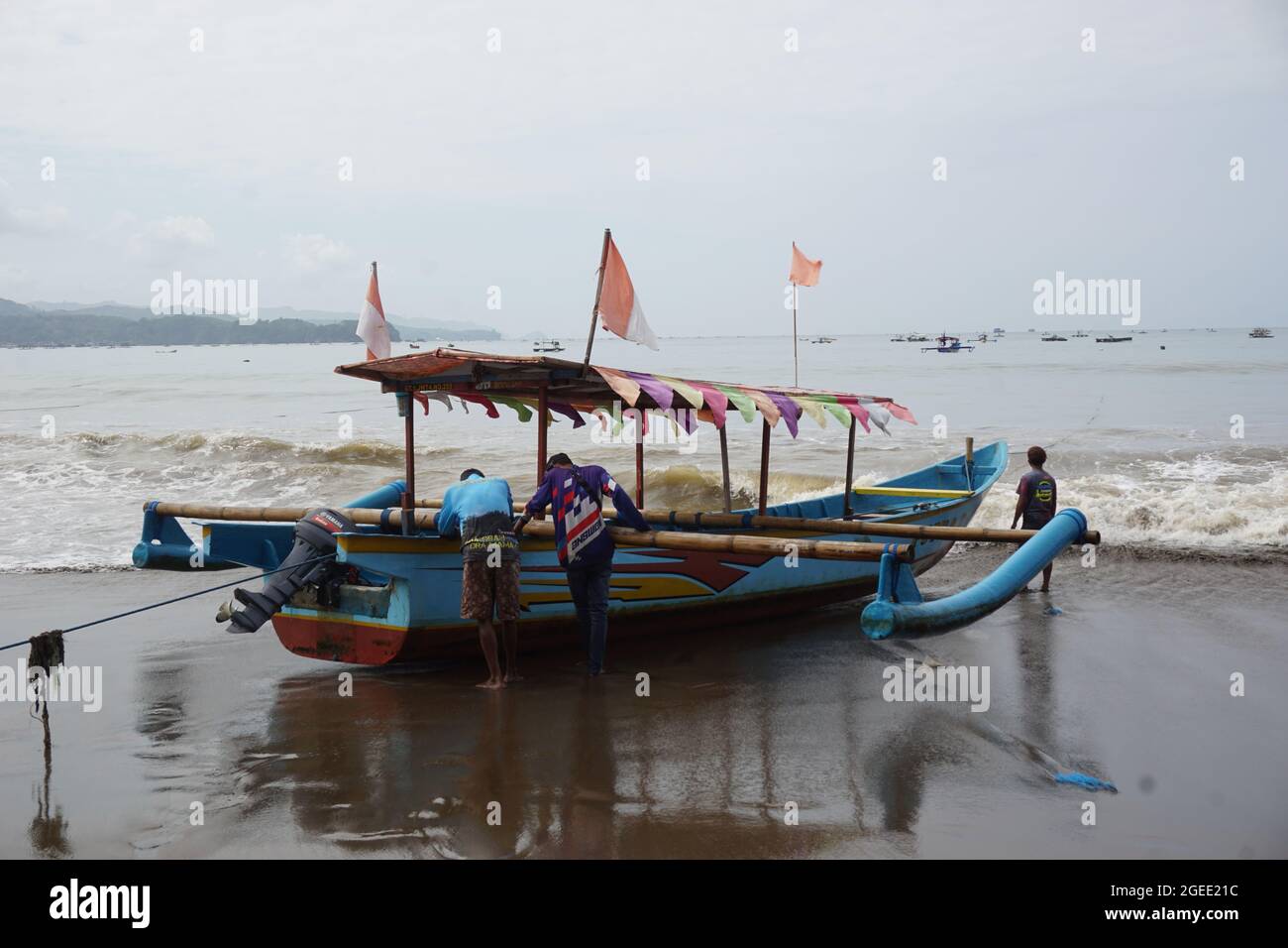 Children are playing on the traditional boat in Gemah Beach, Tulung ...