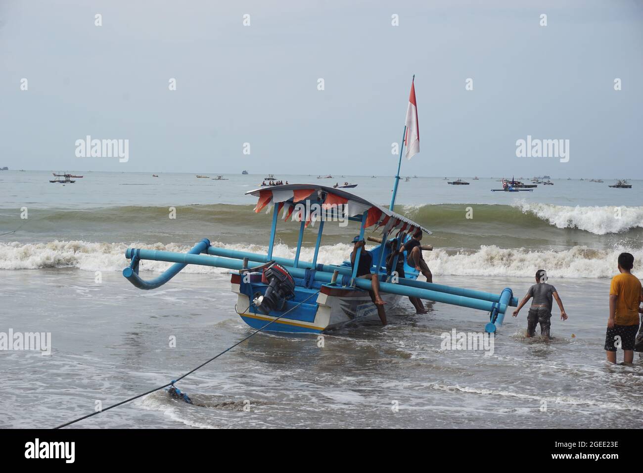 Children are playing on the traditional boat in Gemah Beach, Tulung ...