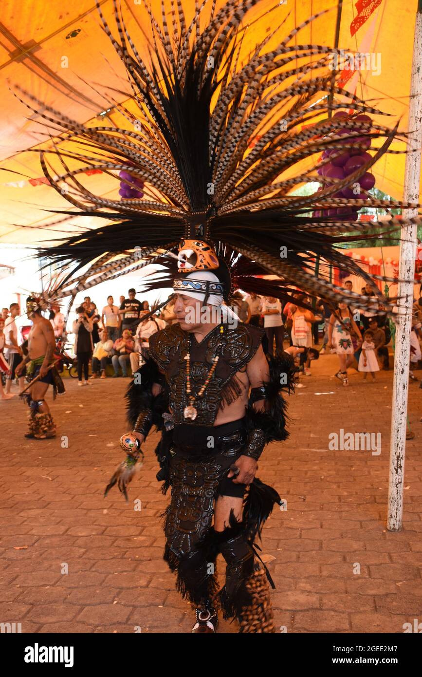 One of the leaders of this Aztec dance group performing a ceremonial ...