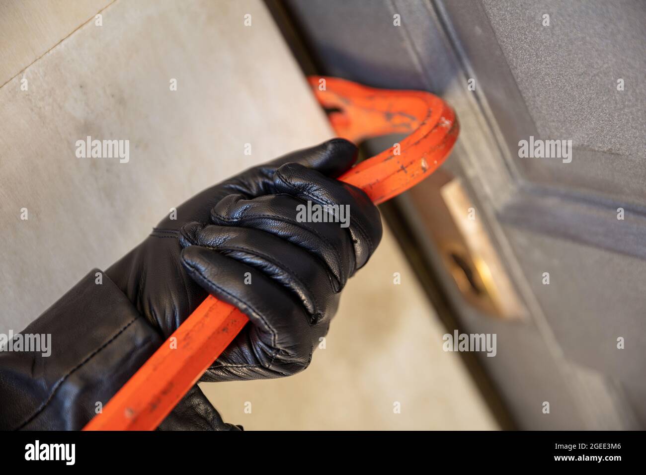 Housebreaker with crowbar. Burglar breaking a house wooden entrance ...