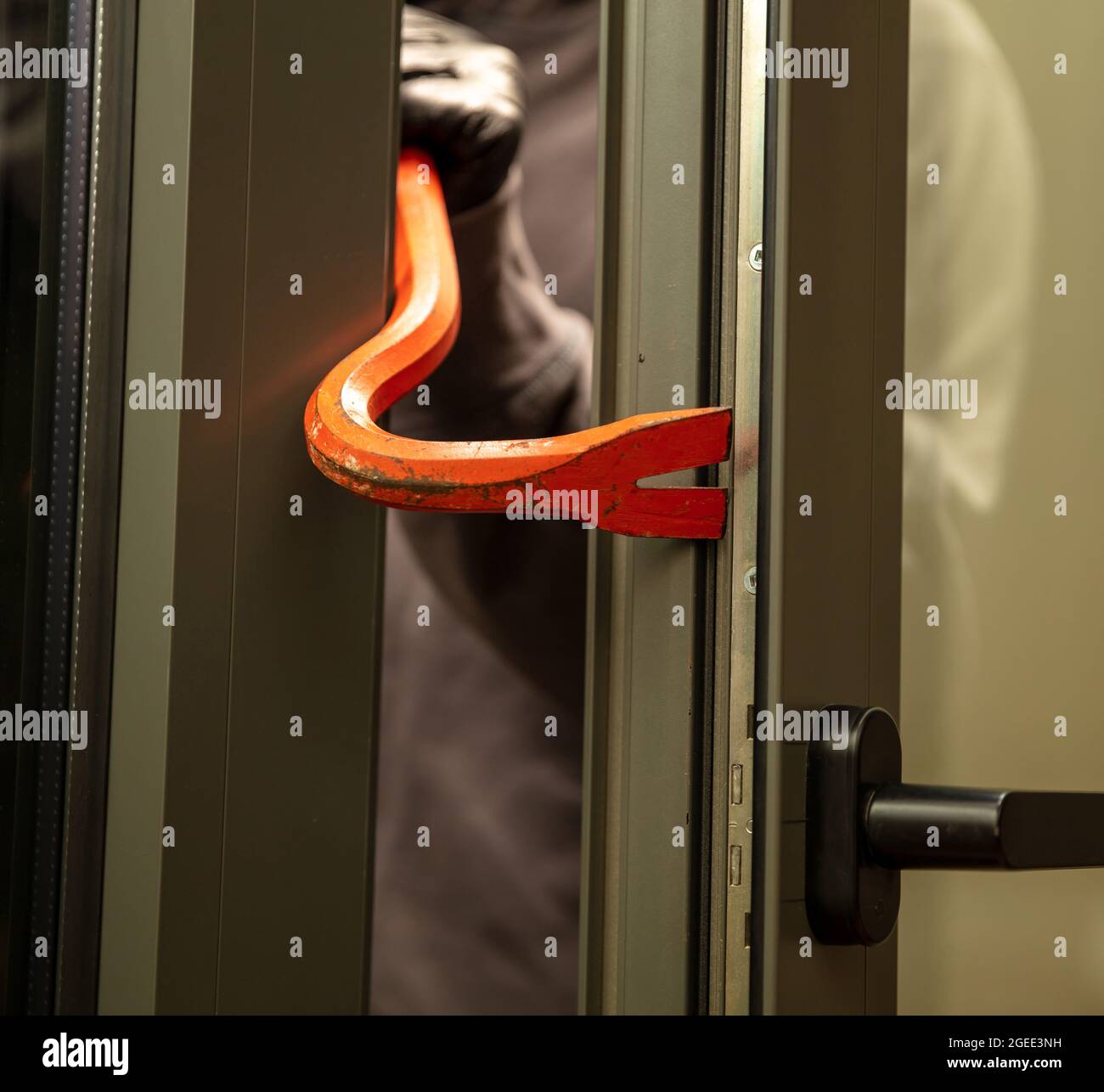 Housebreak with crowbar. Burglar breaking a house aluminum door, for ...