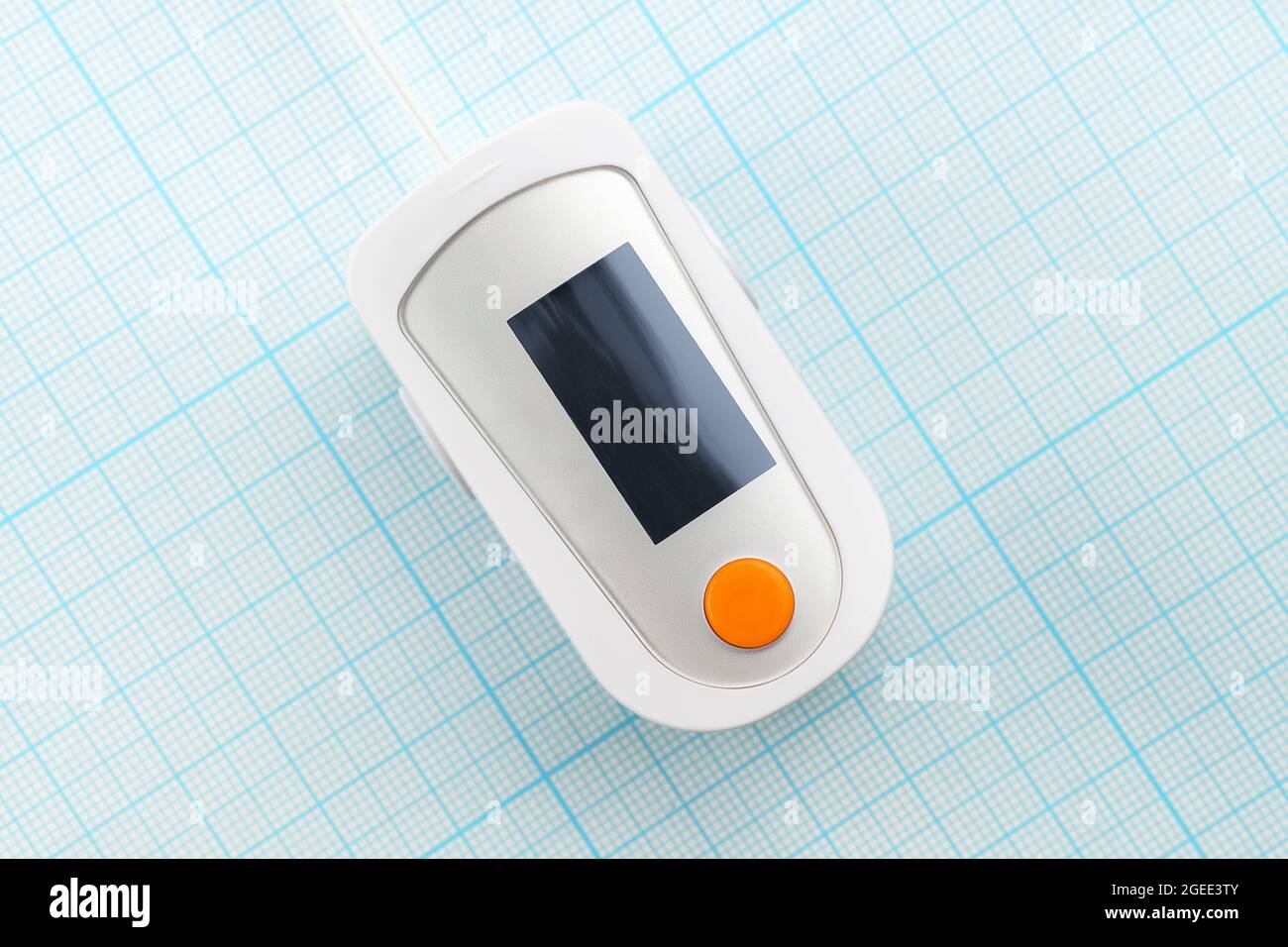 White pulse oximeter on graph paper background. peripheral capillary ...