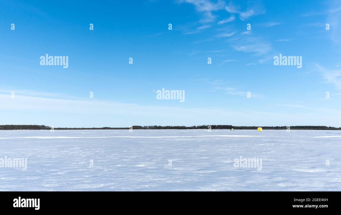 Winter nature and landscape. blue sky and frozen ice lake. Forest at ...