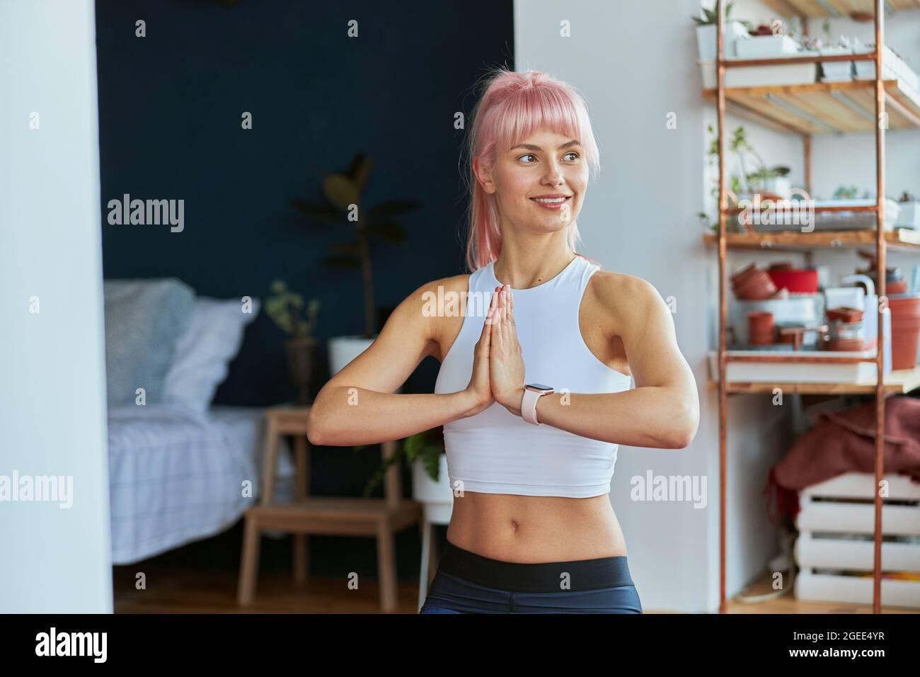 Yoga practitioner does namaste mudra by hands during home training on ...