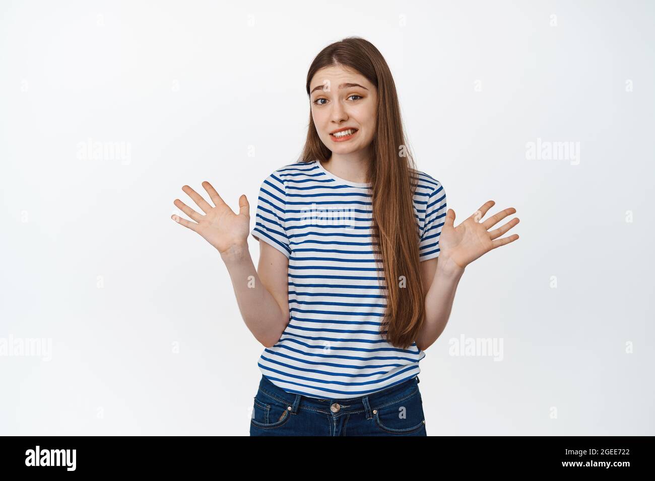 Awkward girl shrugging and showing raised empty hands, nothing to say ...