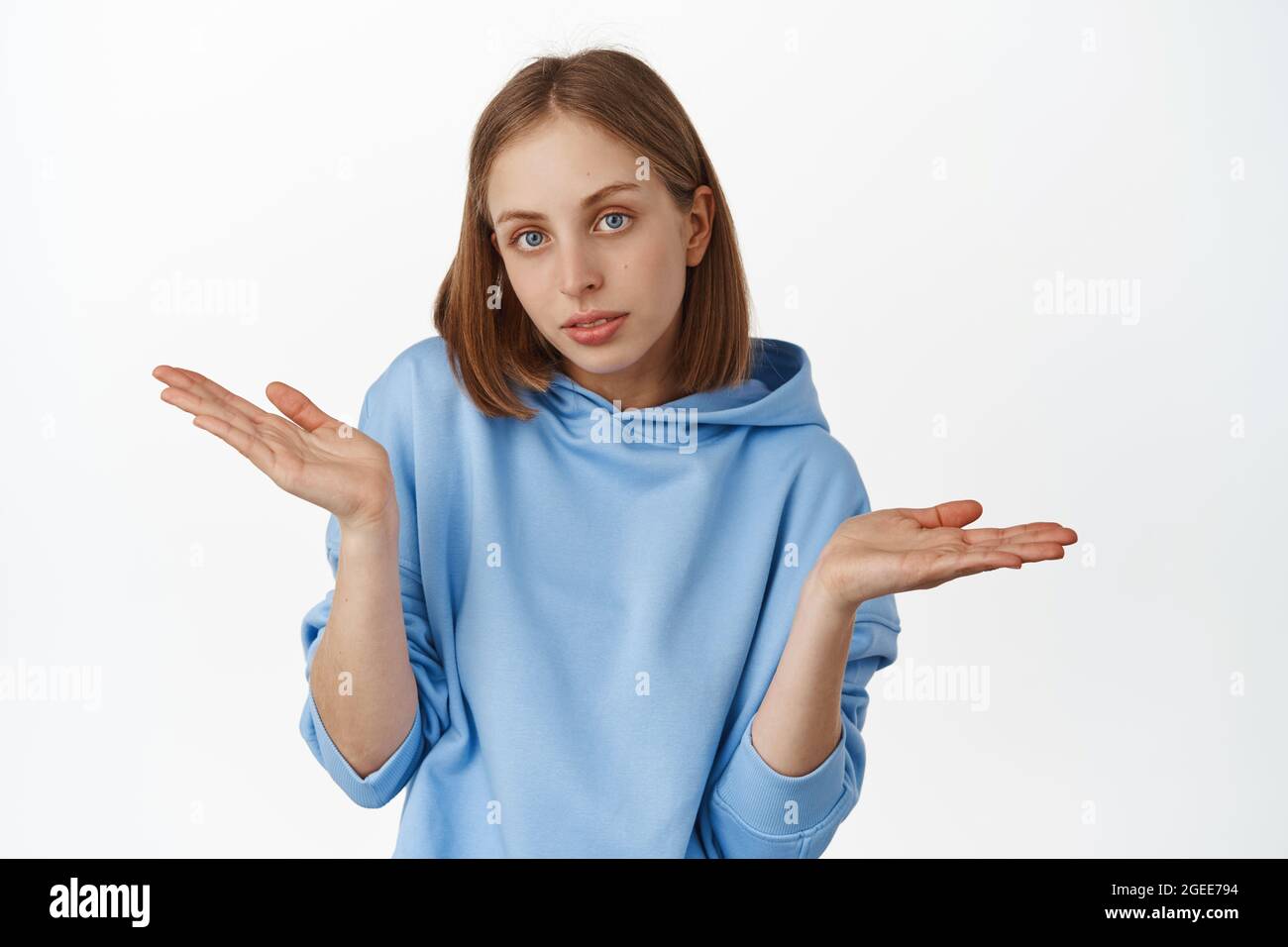 Nothing to say, I dont know. Clueless blond caucasian girl shrugging ...