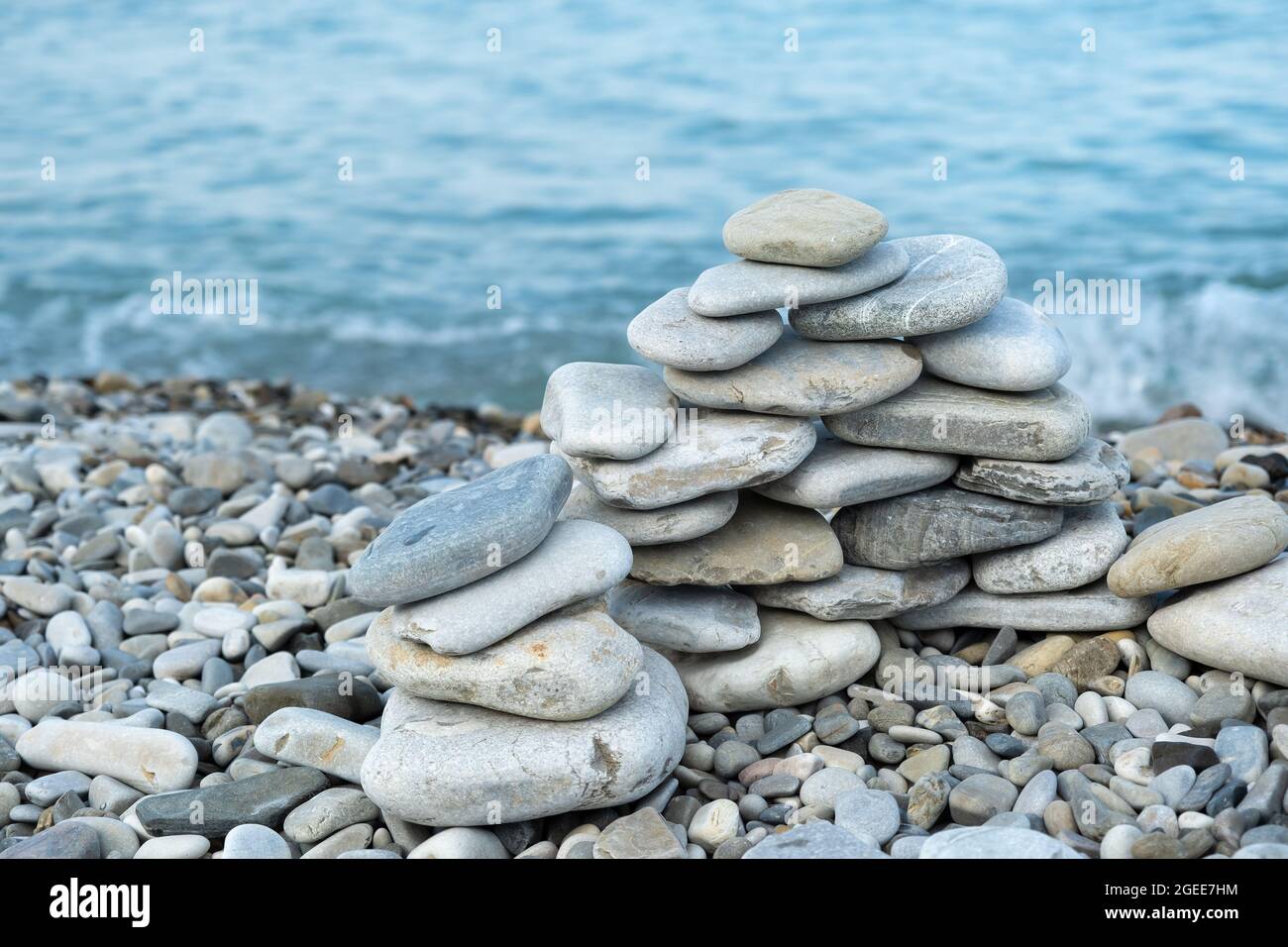 Stacked stone figure on the beach in the morning Stock Photo - Alamy