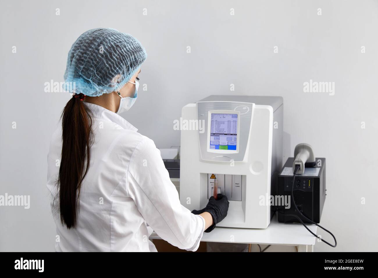 Female Research Scientist Putting Test Tube with Blood Sample into ...