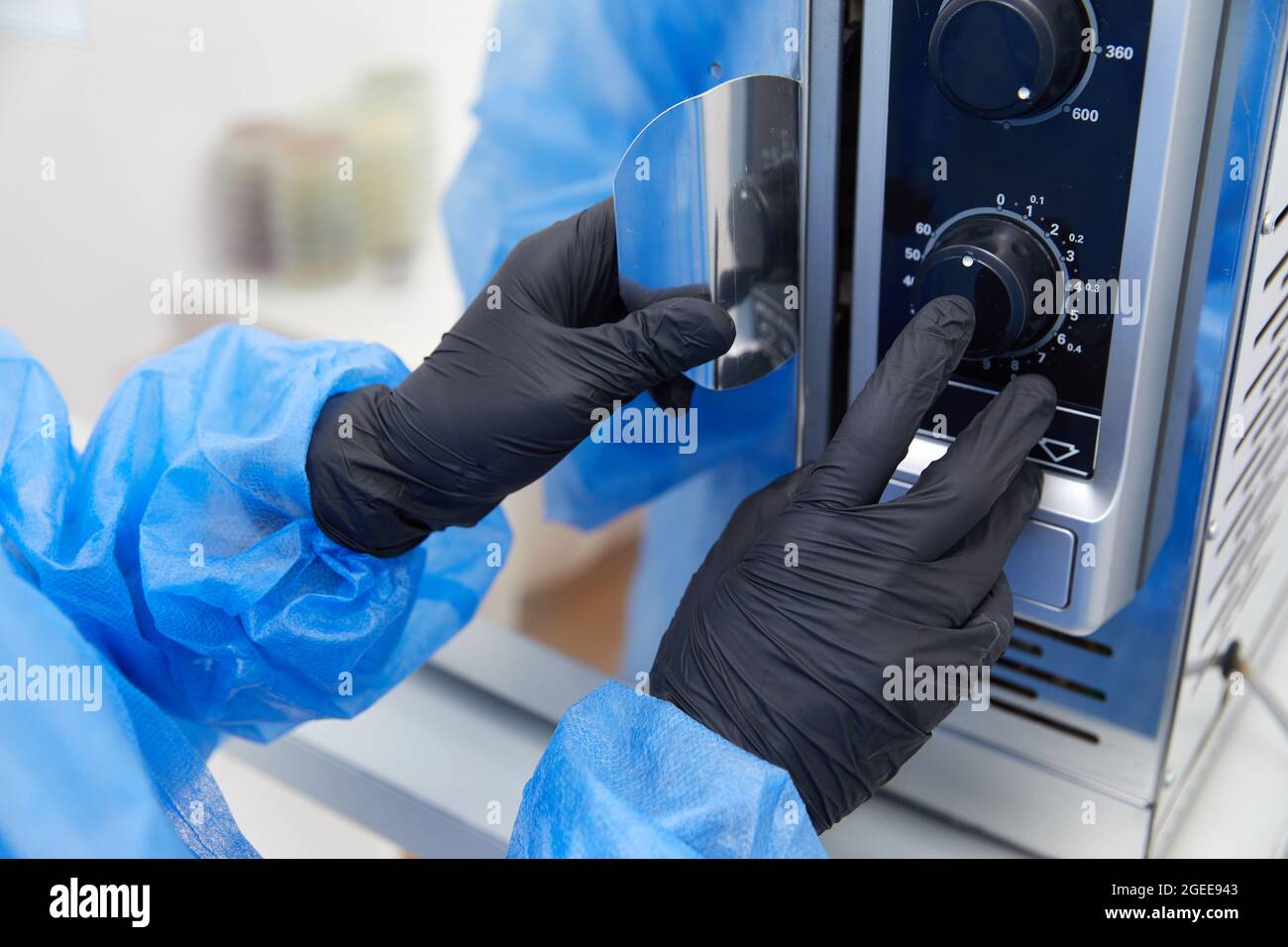 Laboratory worker operating Modern laboratory autoclave sterilizer ...