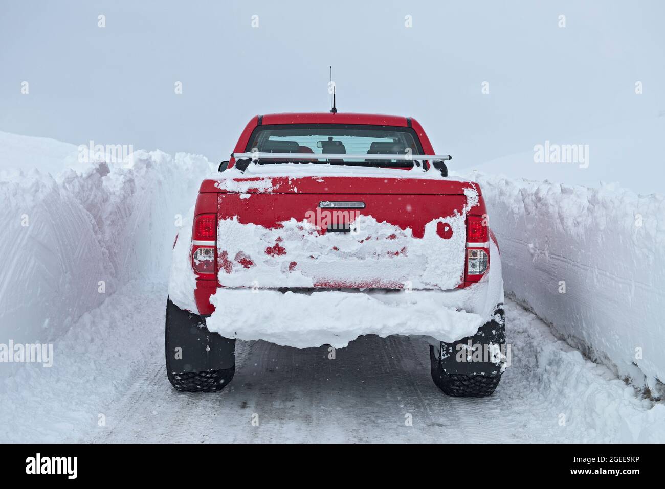customised 4x4 pick up truck driving through deep snow over the ...