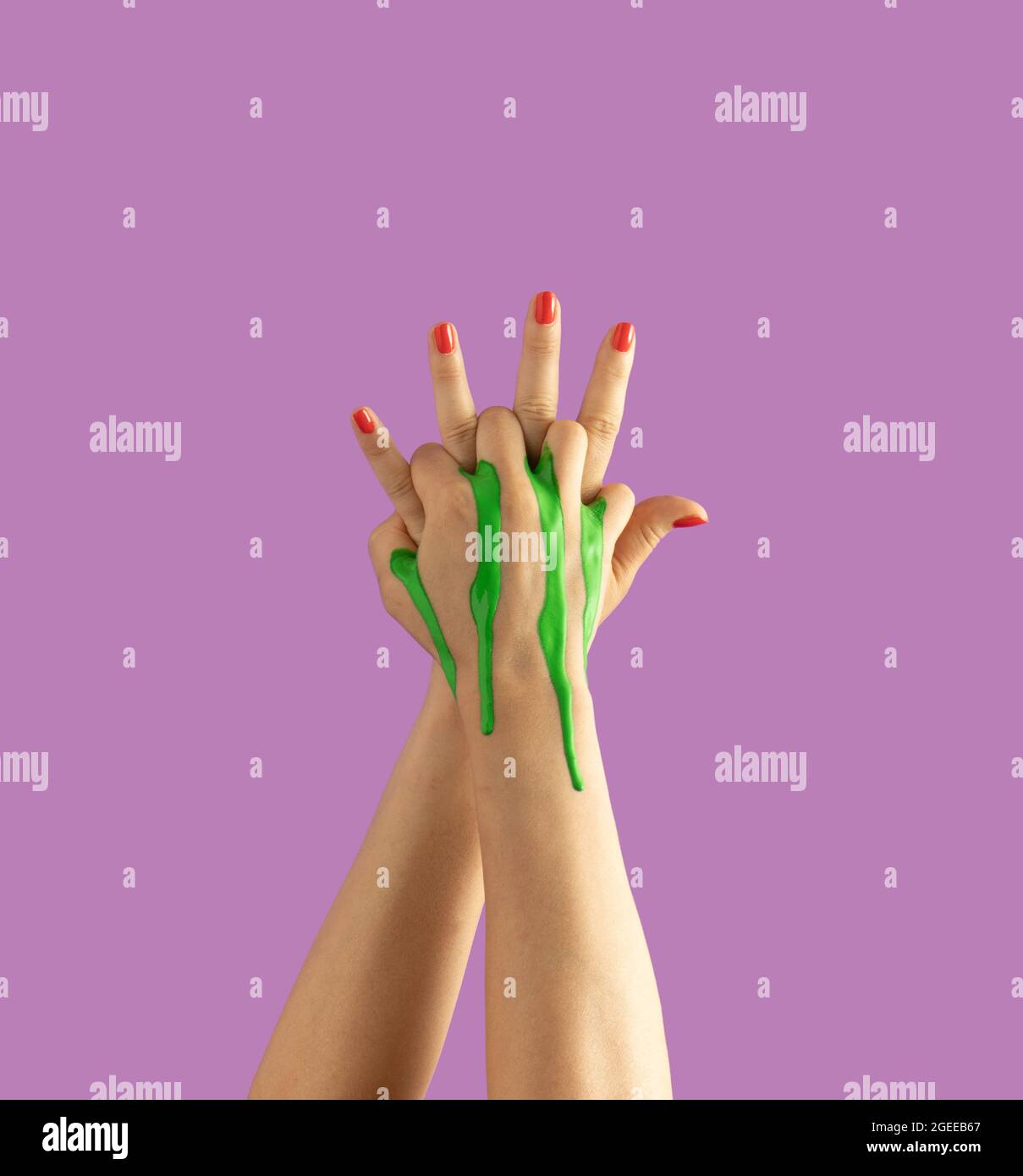 Green streaks of paint dripping down the grabbing hand that goes an ...